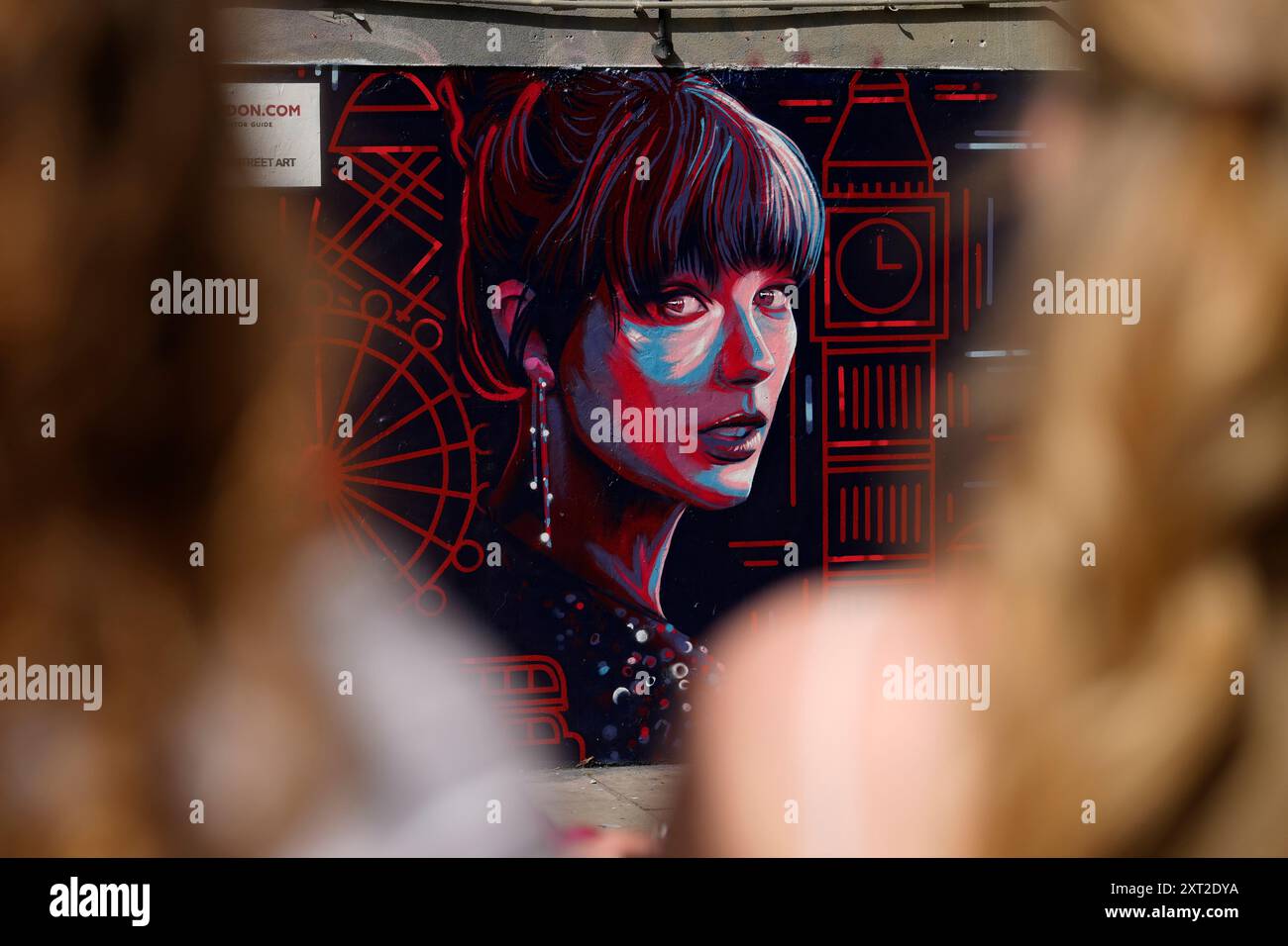 People look at a new mural portrait of Taylor Swift designed by Kate ...