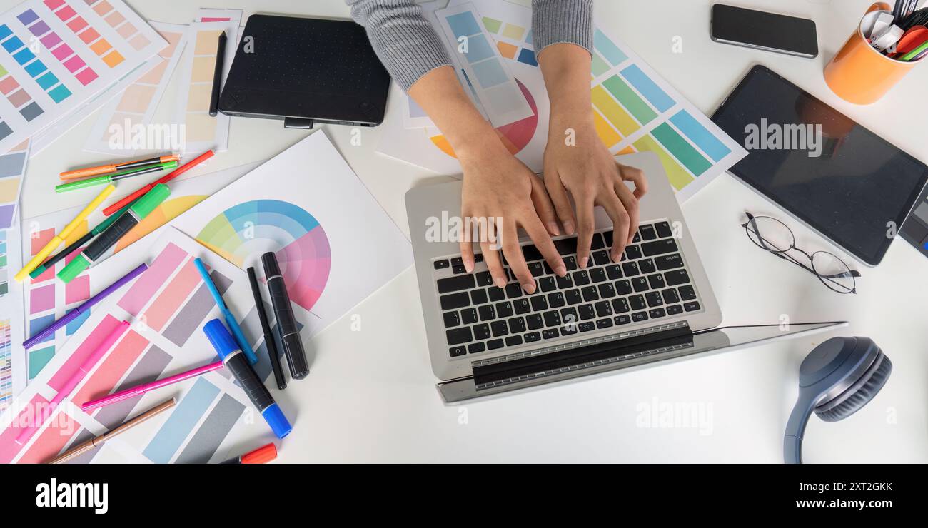 Creative Graphic Designer Working on Laptop with Color Palettes and ...