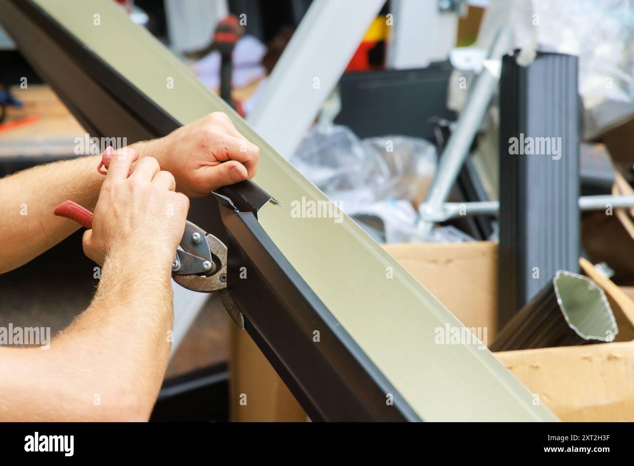 Aluminum rain gutters have been bent by machine tool then cut with ...