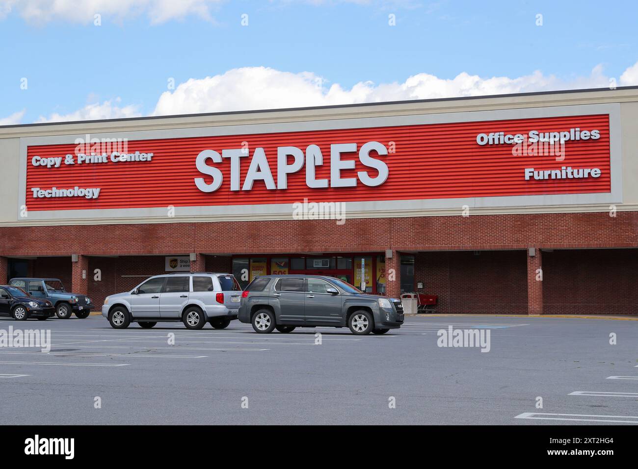 The Staples logo is seen above the entrance to one of its stores ...