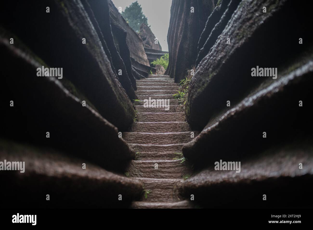 Narrow stone pathway winding though rock formations leading upwards in ...