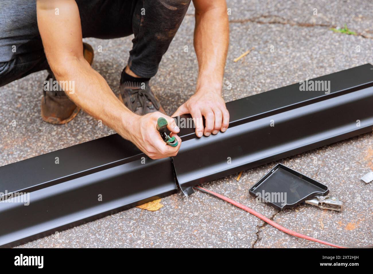 An aluminum rain gutter is bent using machine tool then cut to the ...