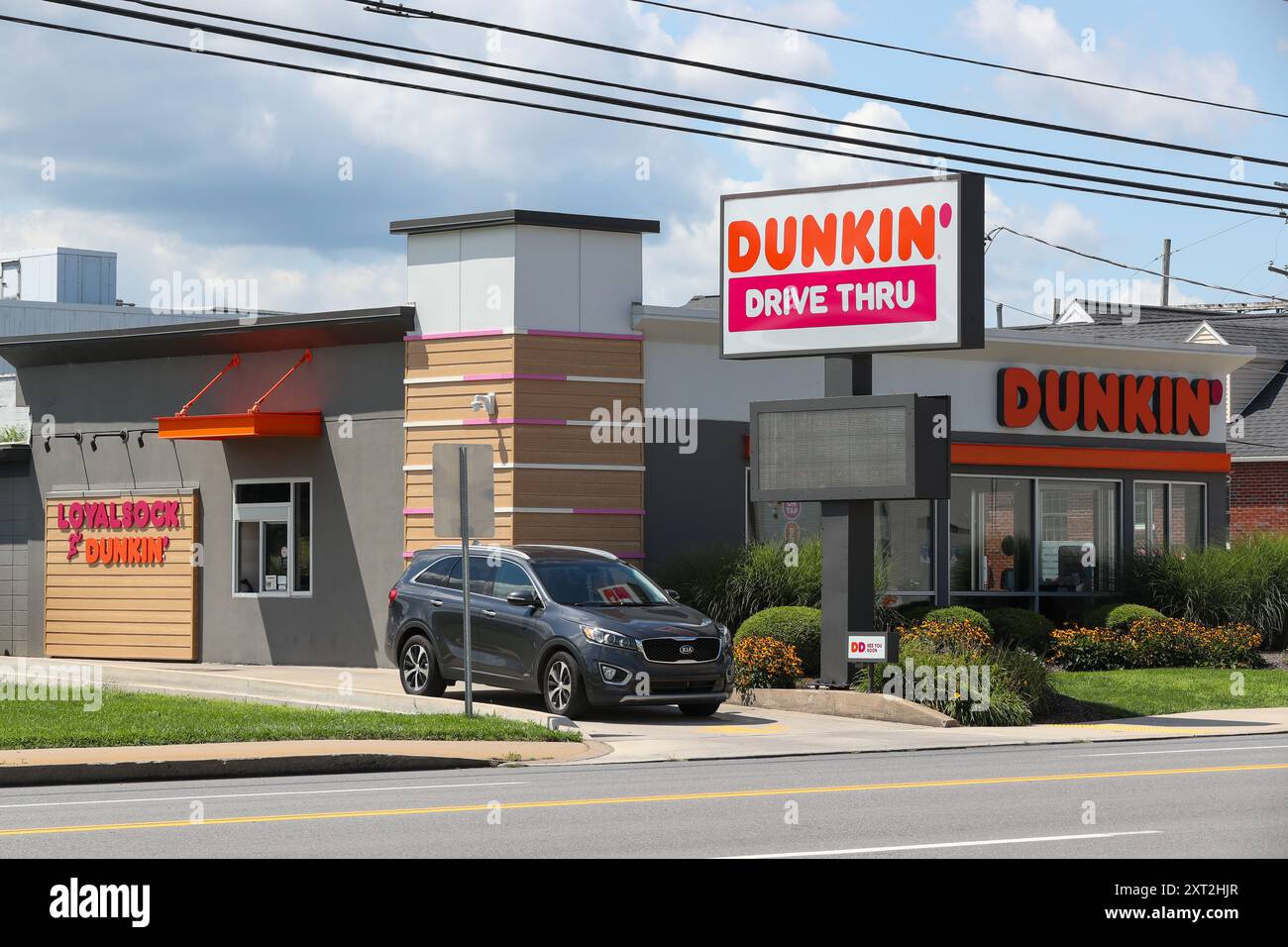 A car exits a Dunkin' drive thru. Dunkin' is the largest American ...