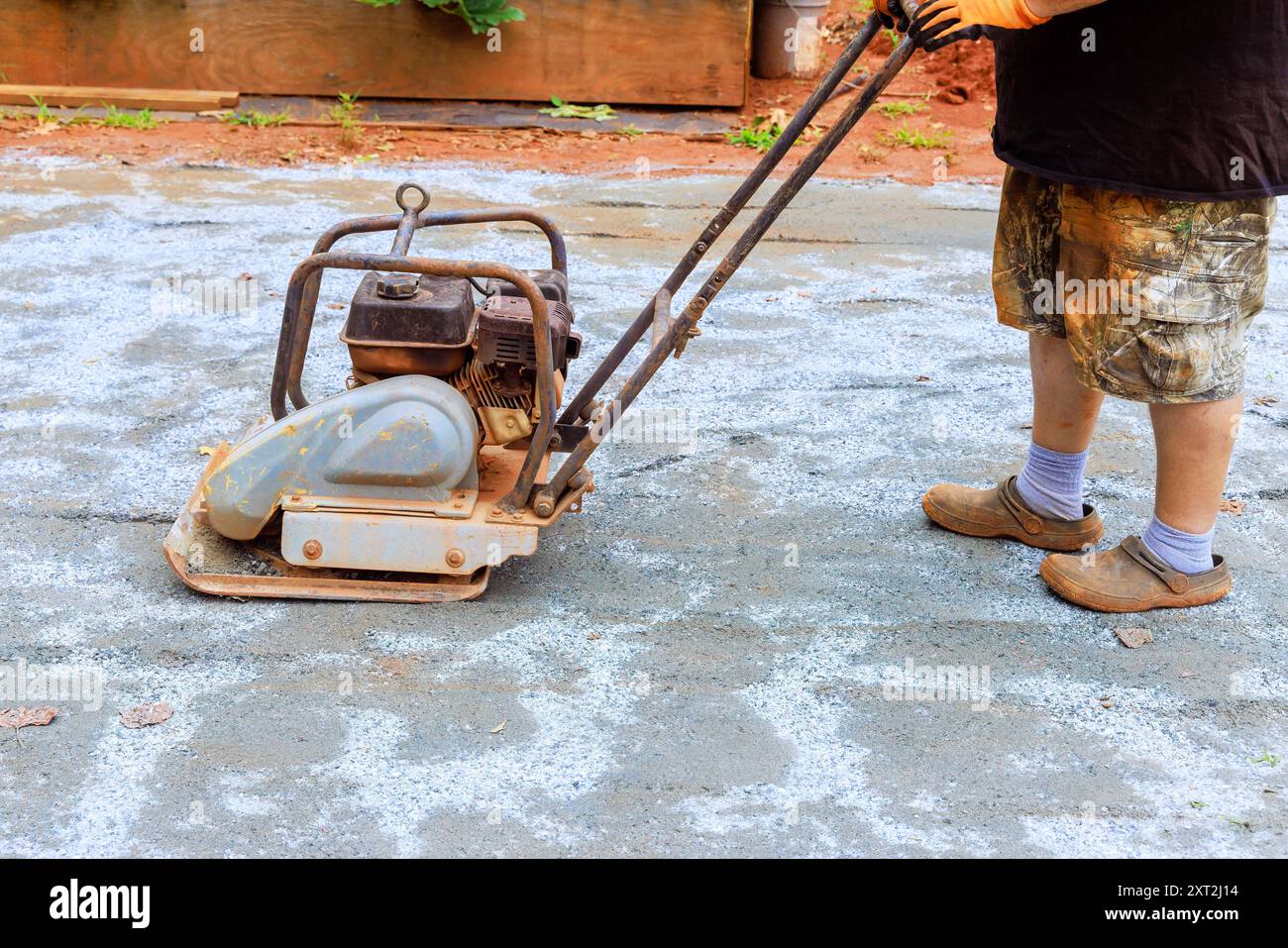 Vibratory tamping machine is used during construction for pool platform ...
