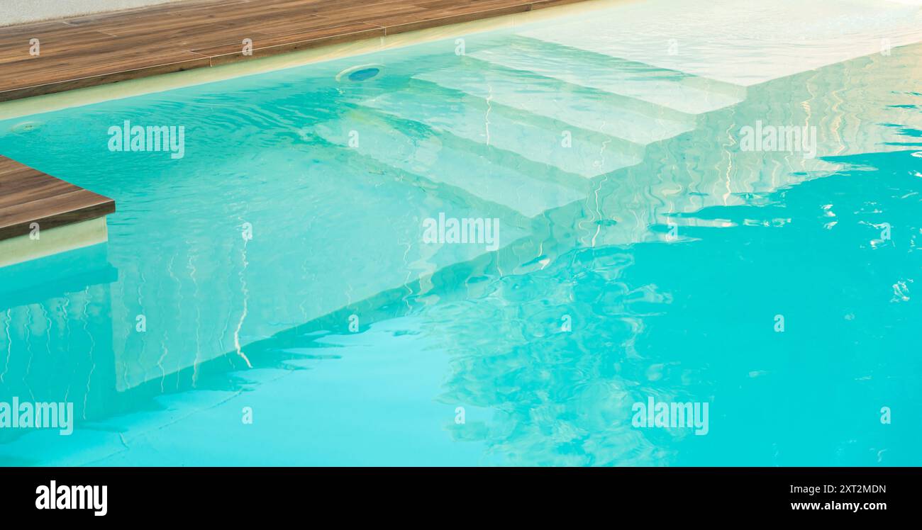 Swimming pool entrance steps with clean blue water at modern villa ...