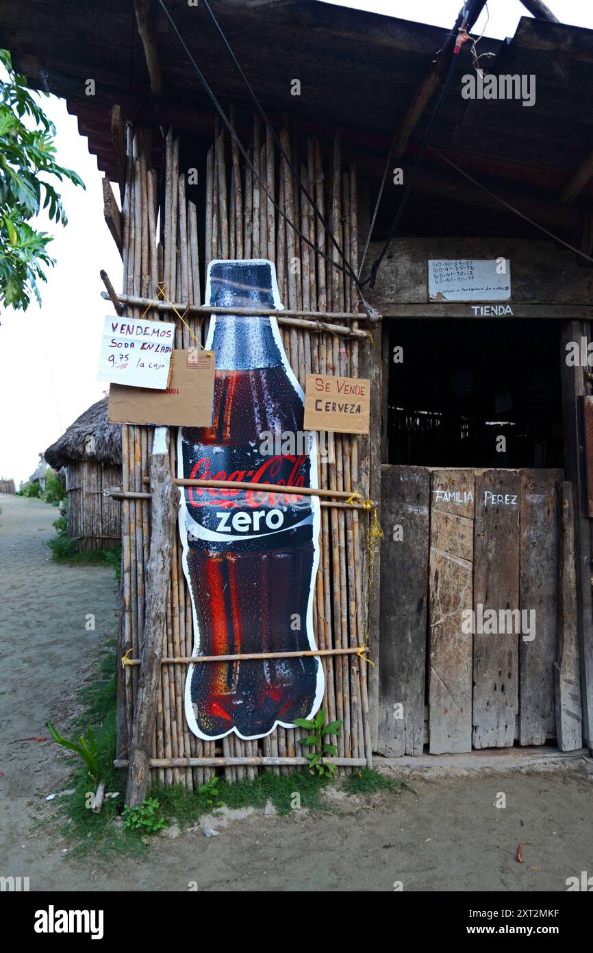 Coca Cola Zero advert on wall of a typical bamboo and palm leaf thatch ...
