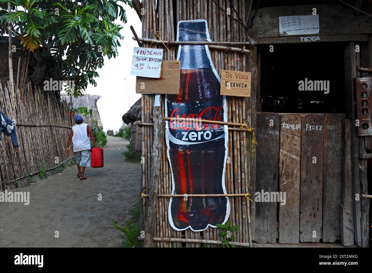 Coca Cola Zero advert on wall of a typical bamboo and palm leaf thatch ...