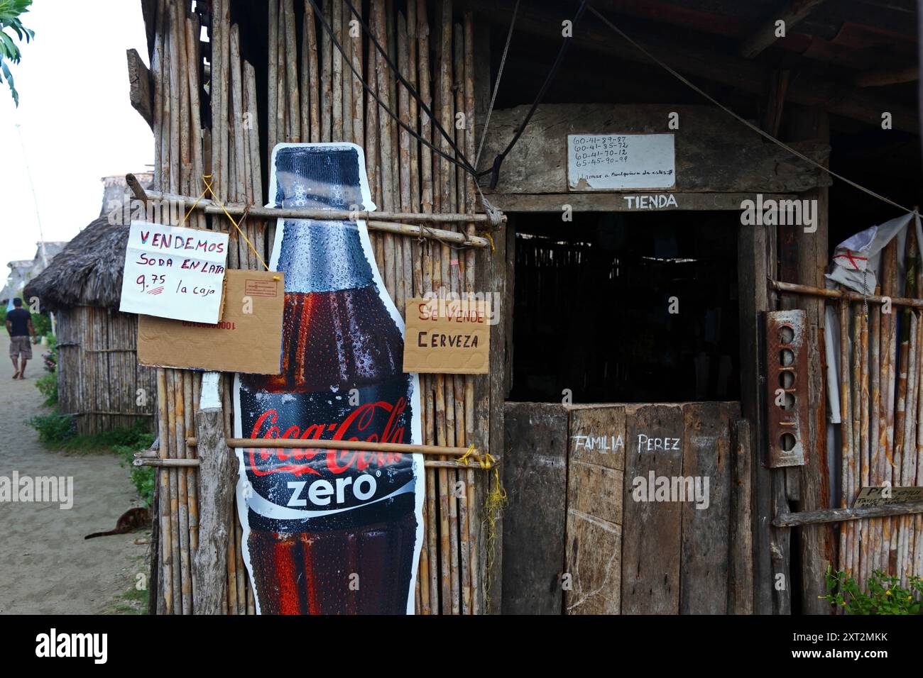 Coca Cola Zero advert on wall of a typical bamboo and palm leaf thatch ...