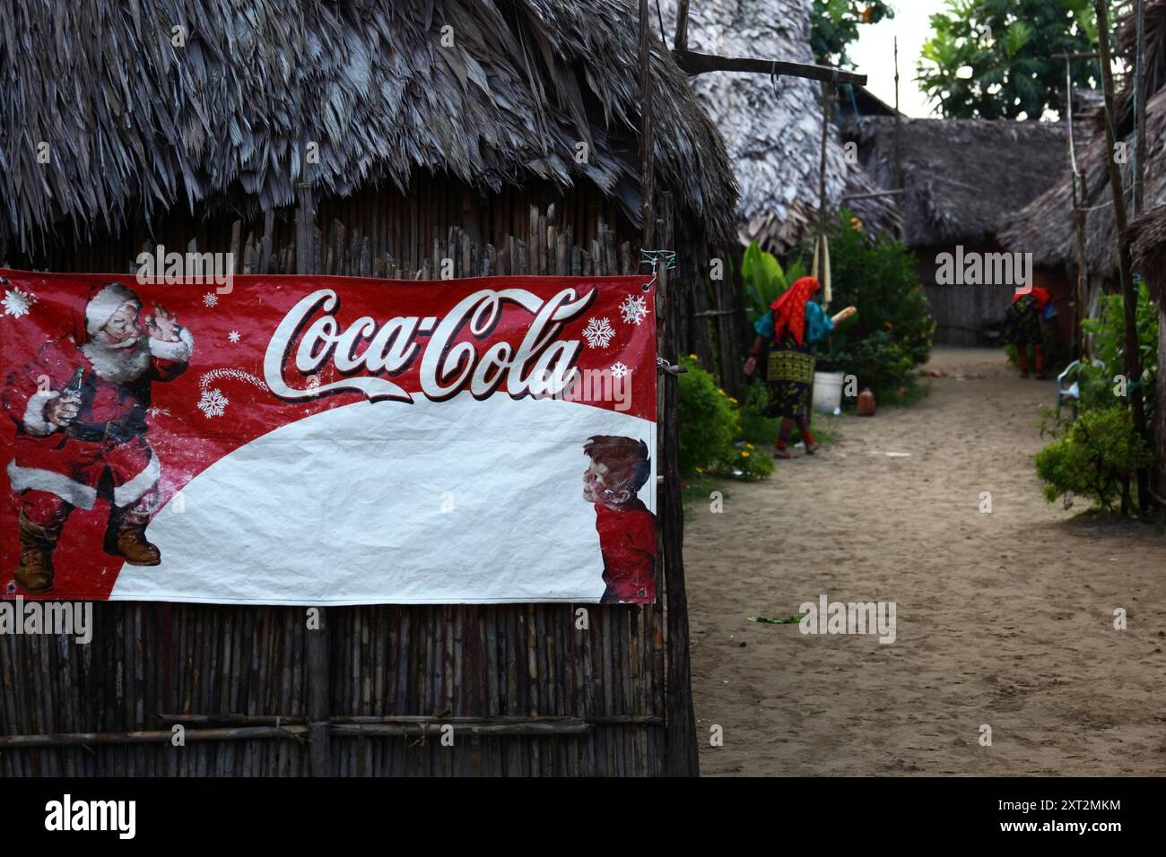 Christmas Coca Cola advert with Santa Claus on wall of a typical bamboo ...
