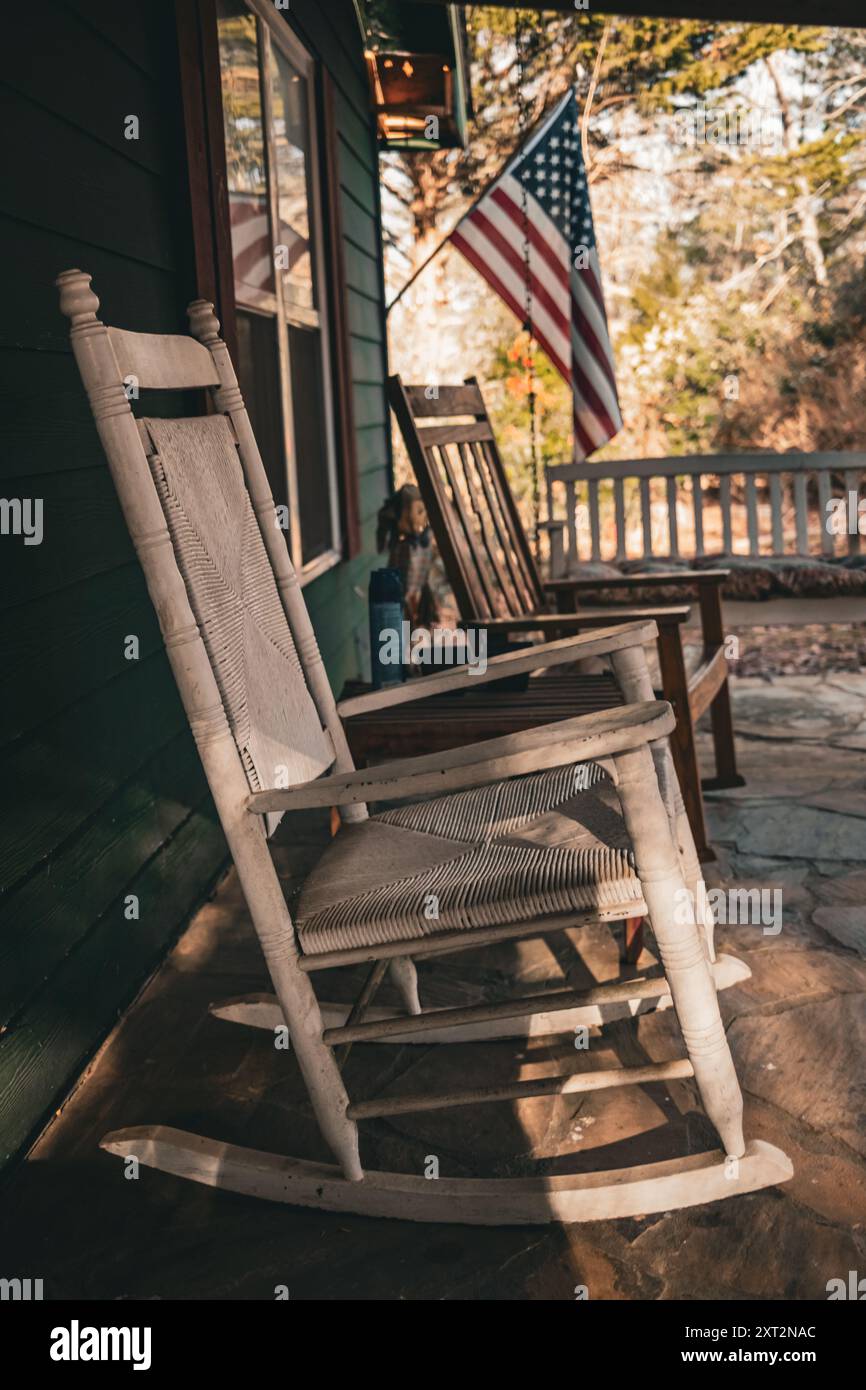 Old-fashioned rocking chair on a porch with an American flag in the ...