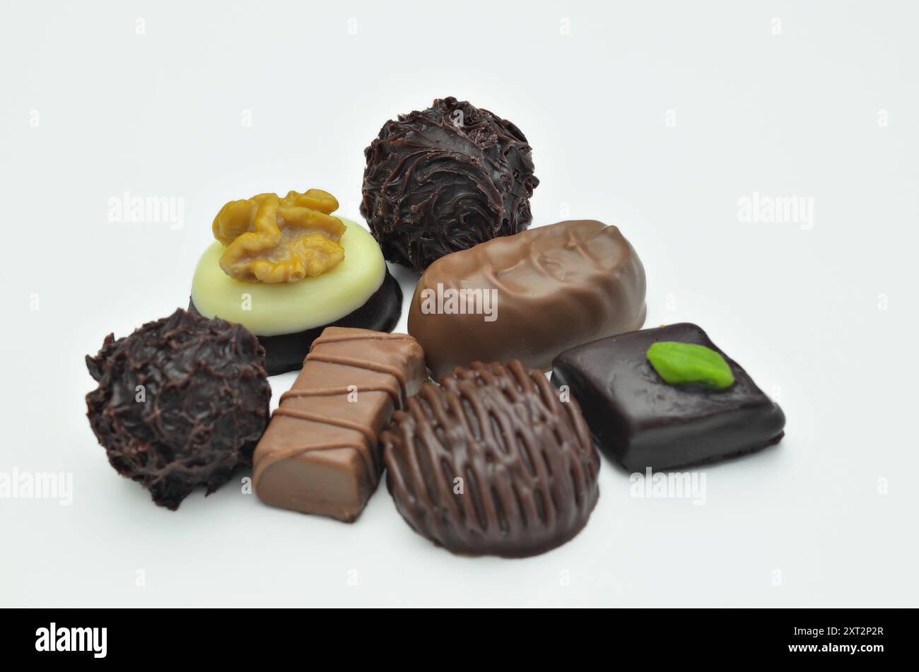 Different kinds of chocolate pralines, close up, isolated on white ...