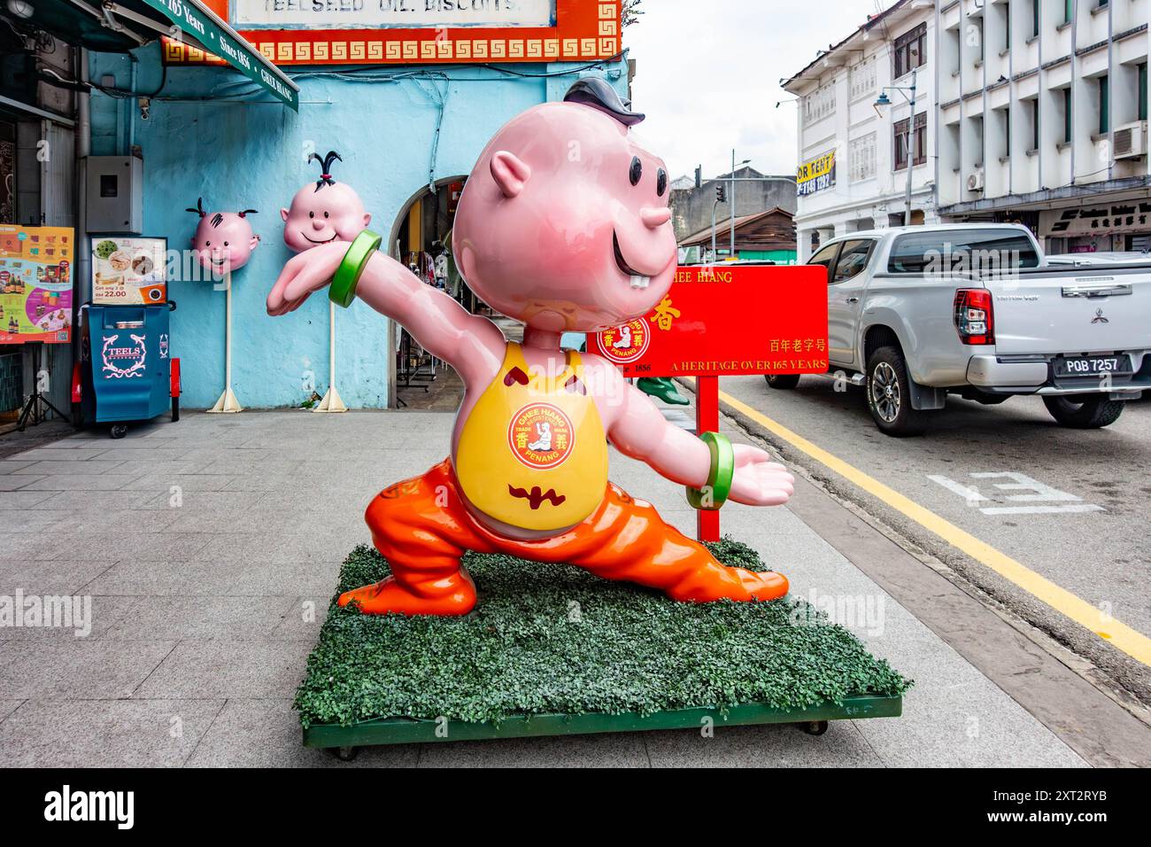 Colourful, cartoon Chinese figures on the pavement outside outside The ...