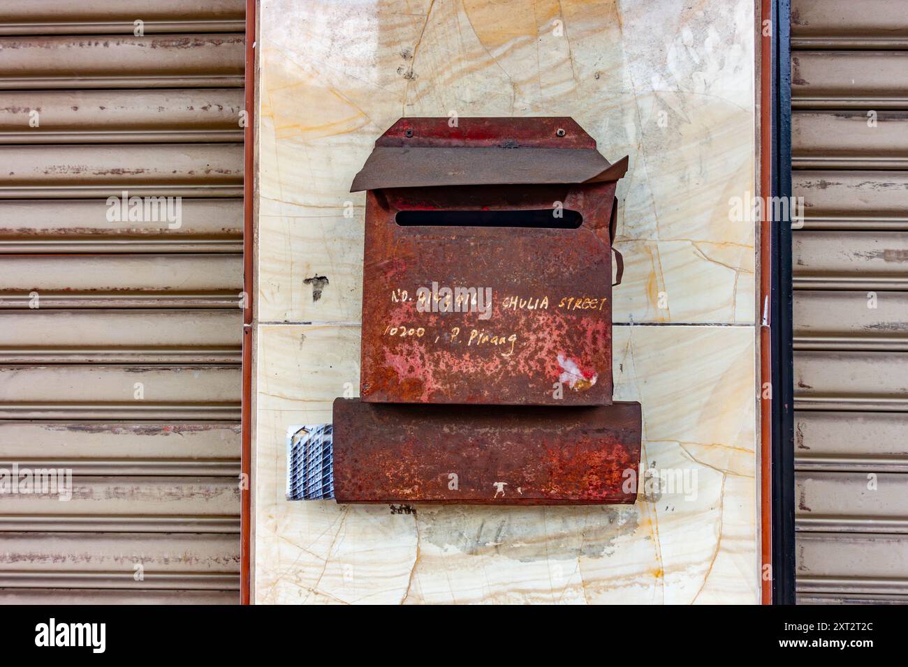 An old, rusty mail box on the wall on Chulia Street in George Town ...