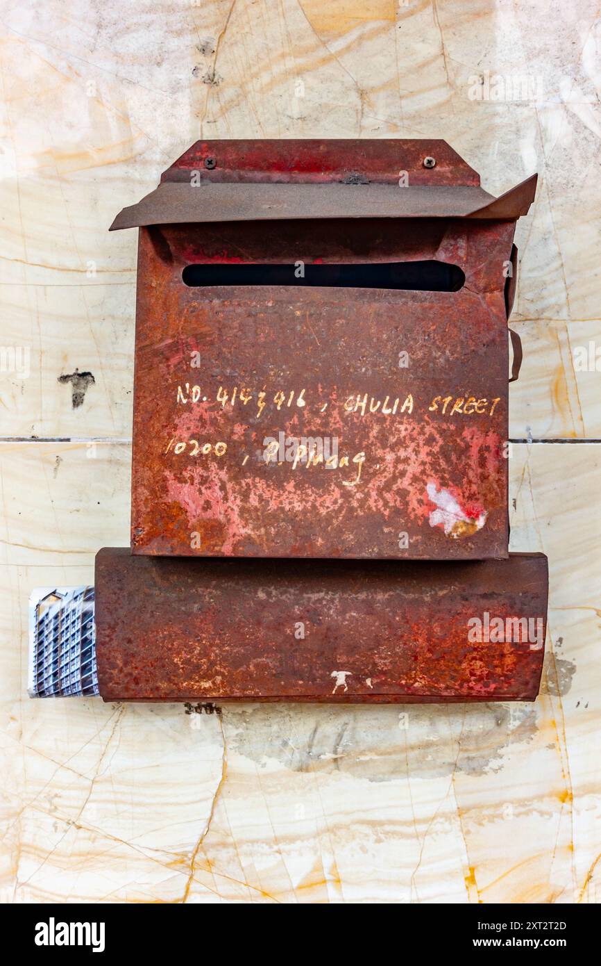 An old, rusty mail box on the wall on Chulia Street in George Town ...