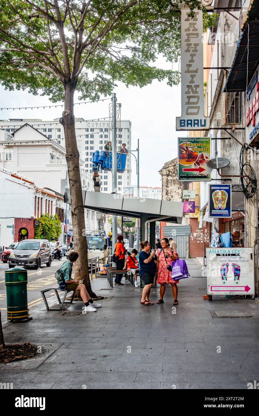 A view along the pavement alongside Penang Street in George Town ...