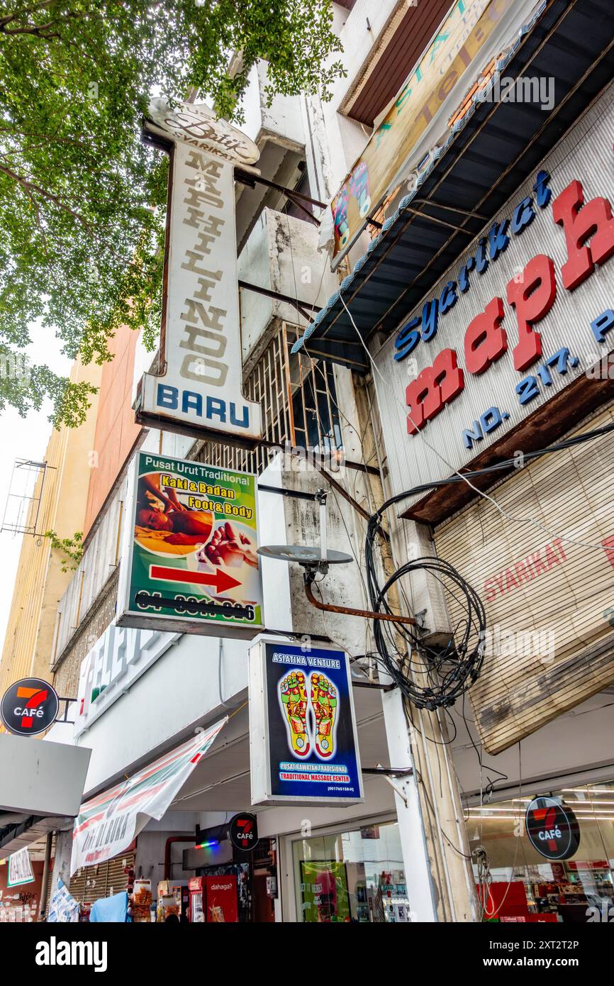 Shop signs advertising services to customers on Penang Road in George ...