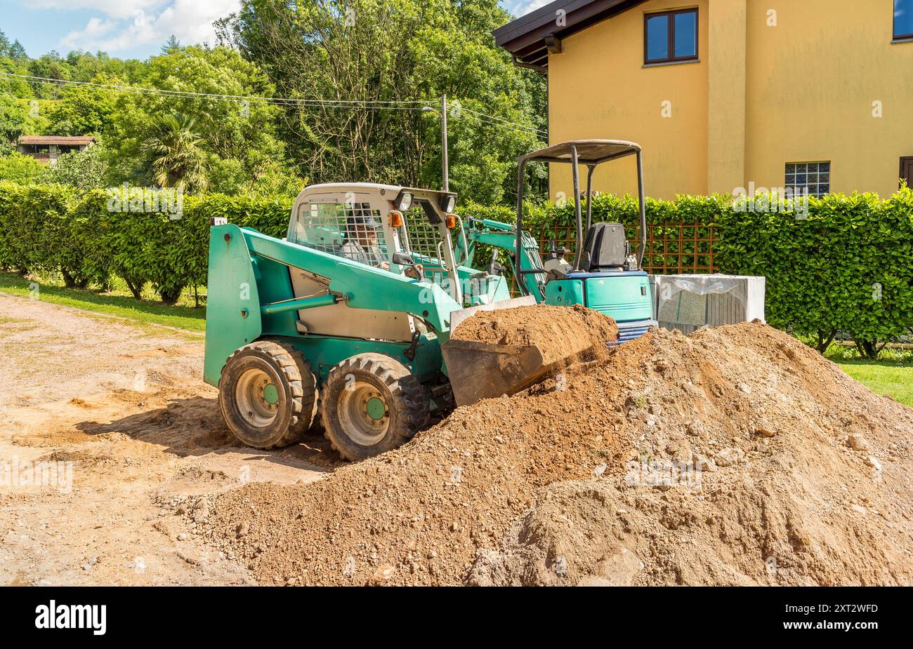 A worker on a Skin Loader is moving soil, excavated in front of the ...
