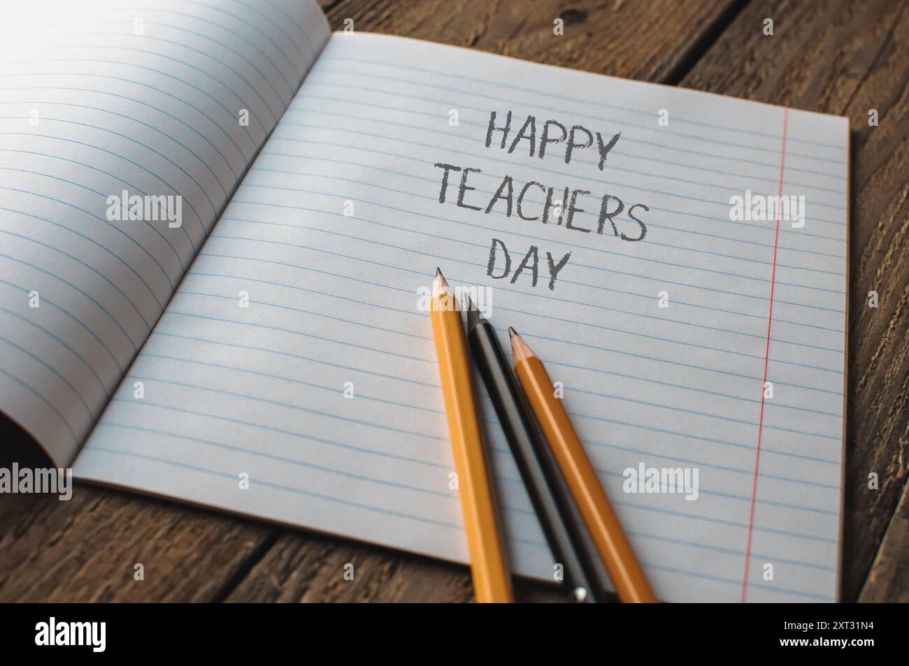 A notebook with pencils and the words Happy Teachers Day written on it ...