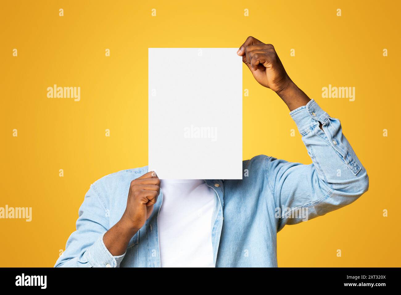 Black guy covering his face with white blank paper Stock Photo - Alamy