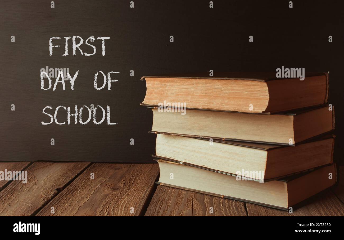 A stack of books with the words First Day of School written on a ...