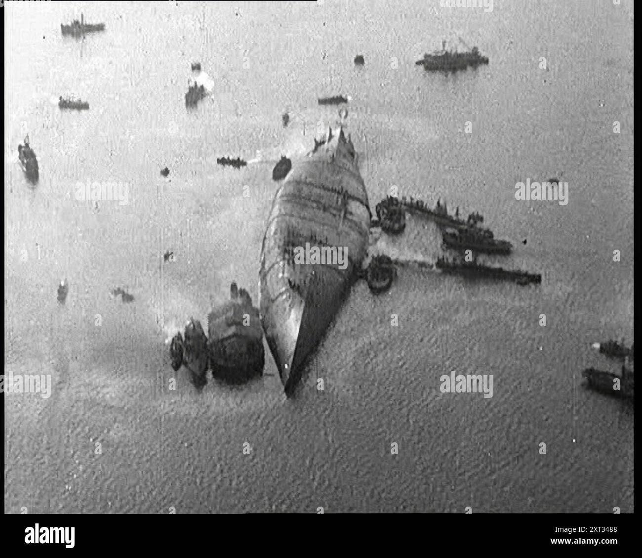 A Capsized Italian Ship at Sea Being Approached by Smaller Vessels ...