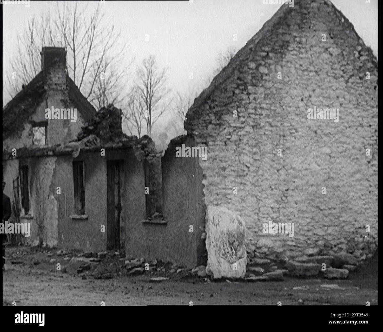 A Man Standing Outside a Burnt Out Cottage in Ireland, Holding a ...