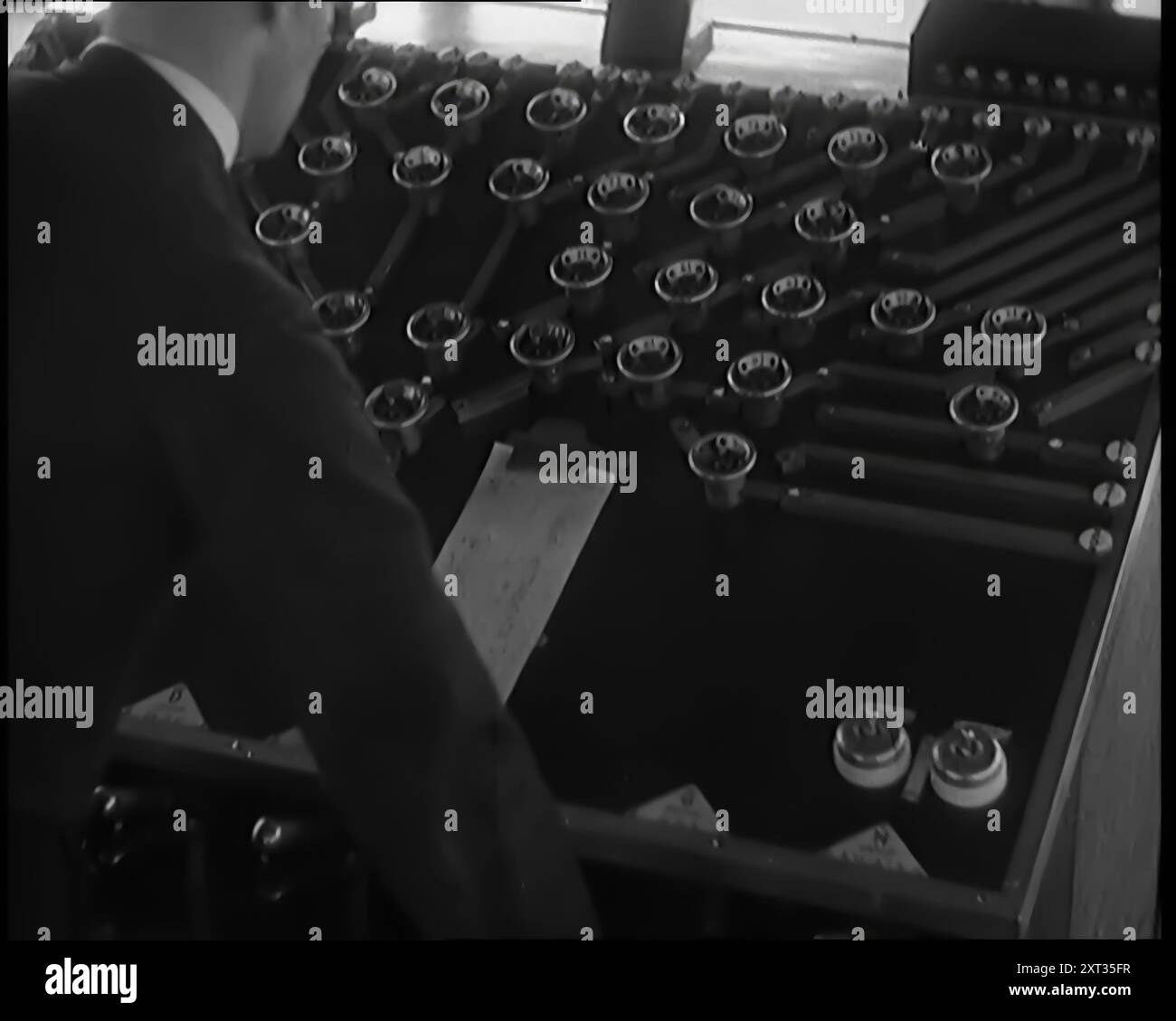 A Male Civilian Using System of Levers and Cogs To Make the Automated ...