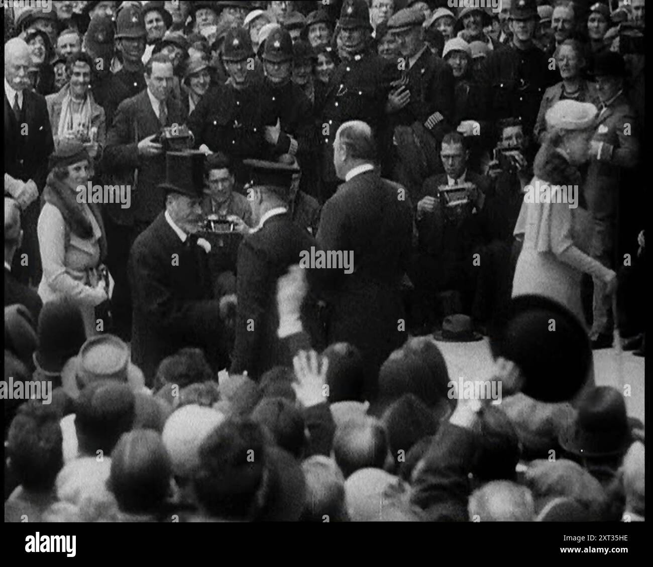 King George V and Other Well Dressed Men and Women Walking Through a ...