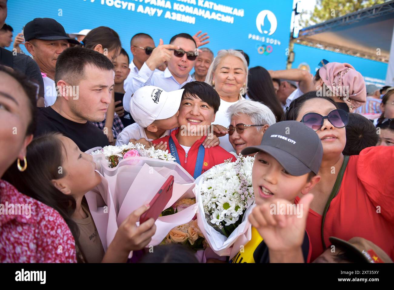 Bishkek. 13th Aug, 2024. Meerim Zhumanazarova (C), silver medalist of women's freestyle 68kg of ...