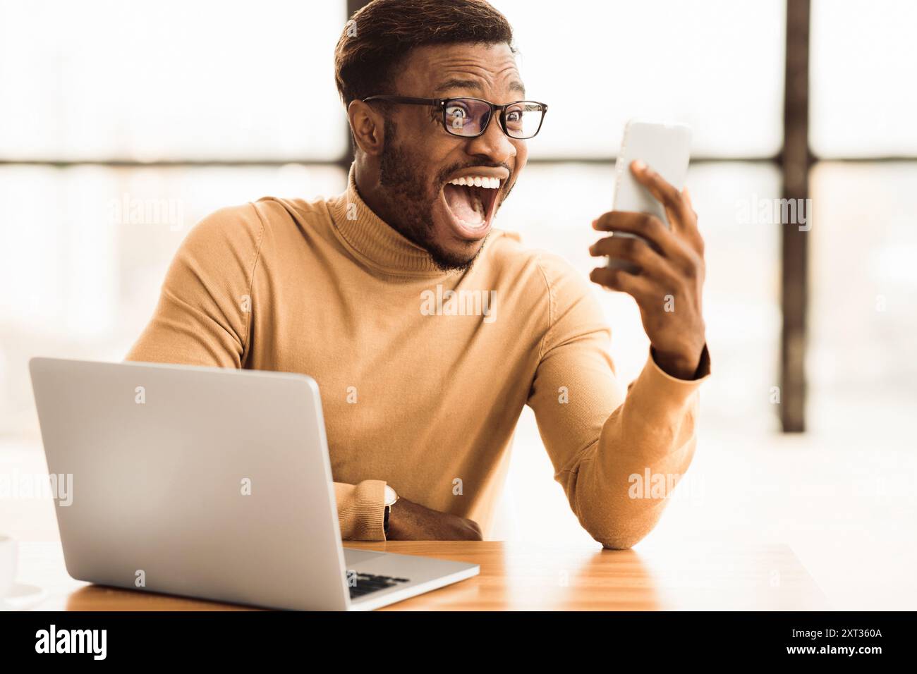 Surprised black guy winning money in lottery Stock Photo - Alamy
