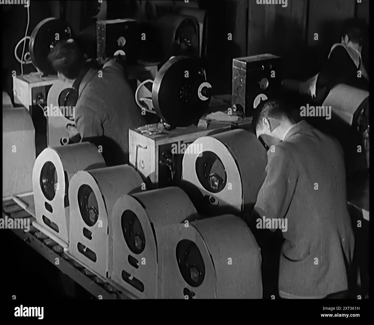 Male and Female Civilians Building Radio Wireless Sets in a Factory ...