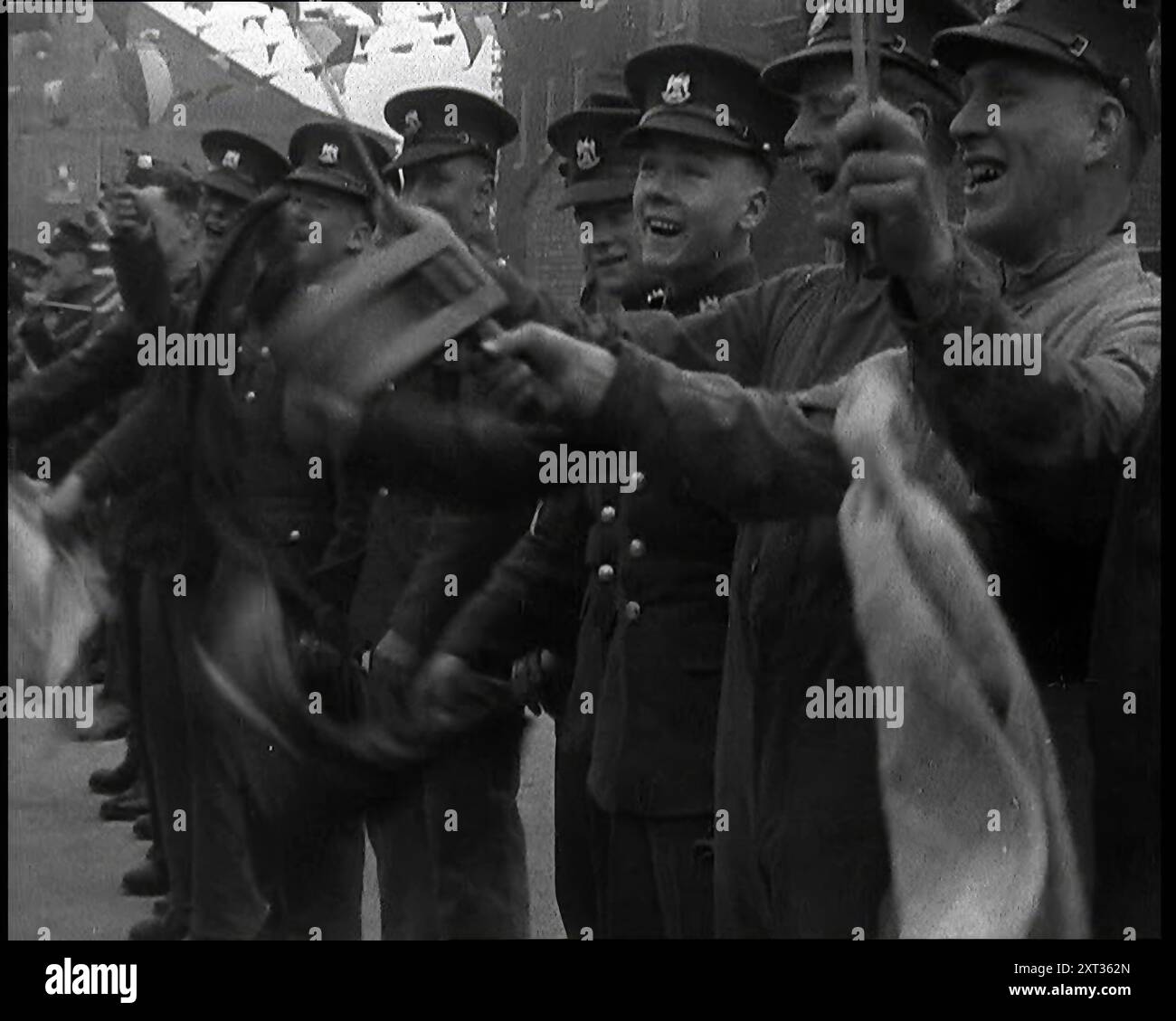 Uniformed British Soldiers Cheering and Smiling Whilst Waving Flags ...