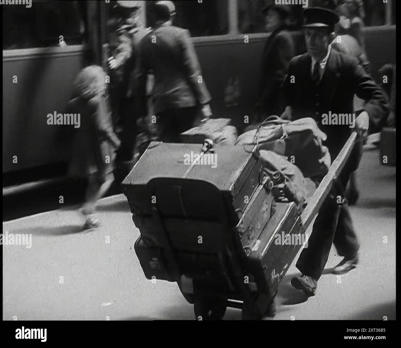 A Male Train Station Porter Pushing a Sack Barrow With Suitcases and ...