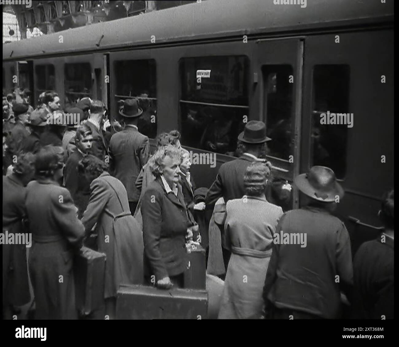 Male and Female Passengers, Some Holding Suitcases, on a Platform of a ...