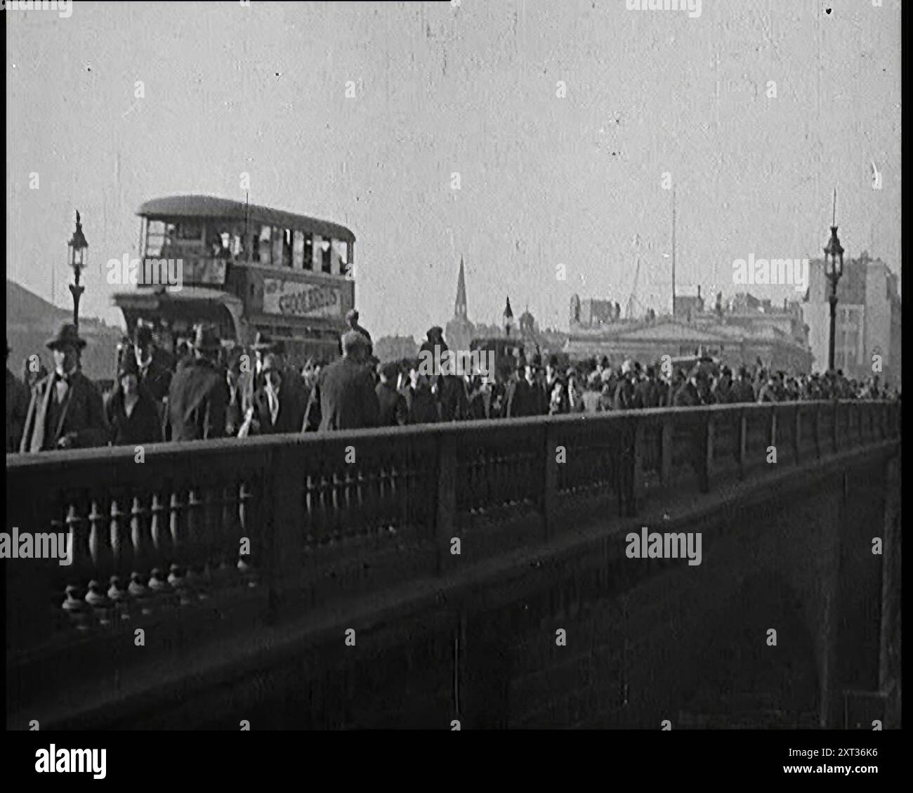 Pedestrians And Commuters Crossing London Bridge With Buses in the ...