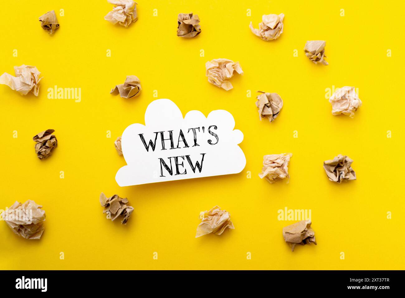A yellow background with a white cloud and the word What's New written ...