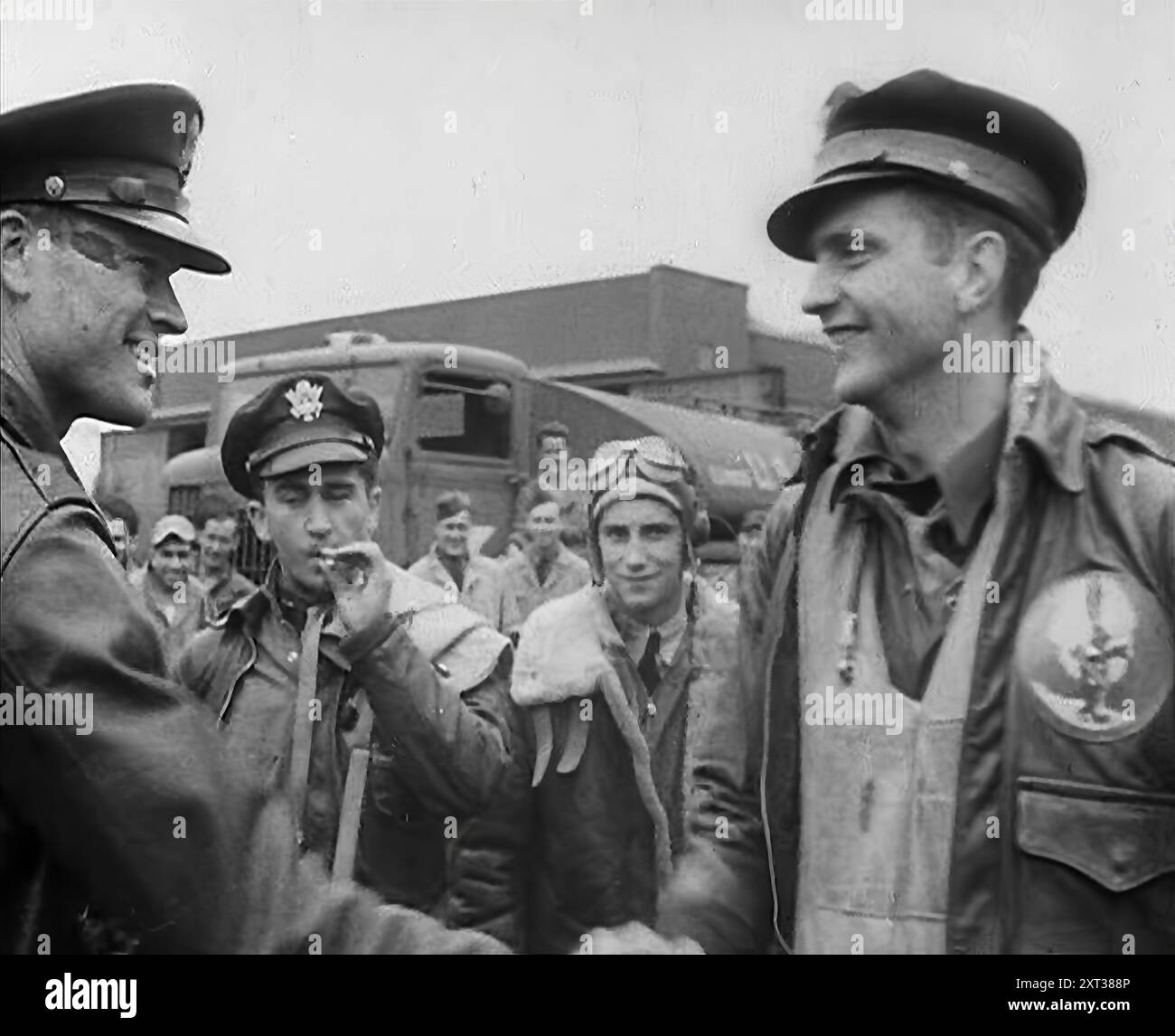 A Male Pilot Shaking Hands with an Officer, whilst other Pilots are ...