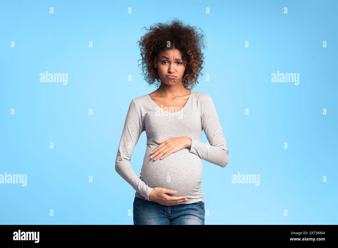 Hormones and mood changes. Sad expectant woman touching belly Stock ...
