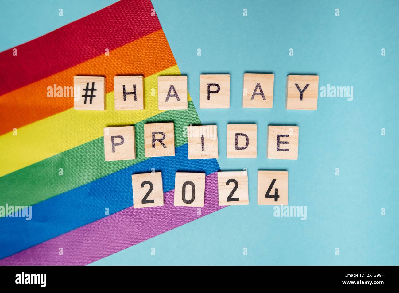 A rainbow flag with the hashtag HappyPride2024 Stock Photo - Alamy