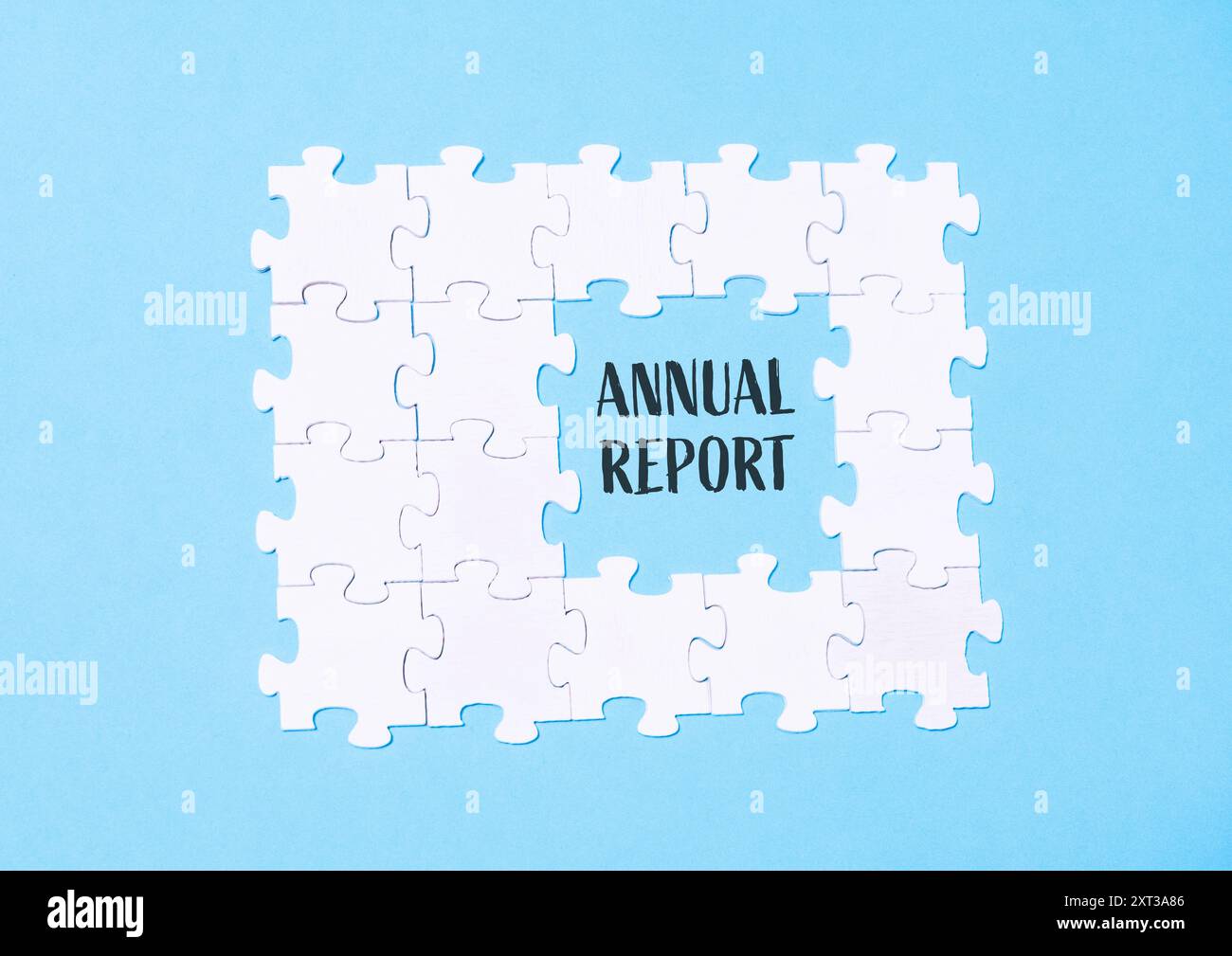 A jigsaw puzzle with the words Annual Report written in the middle ...