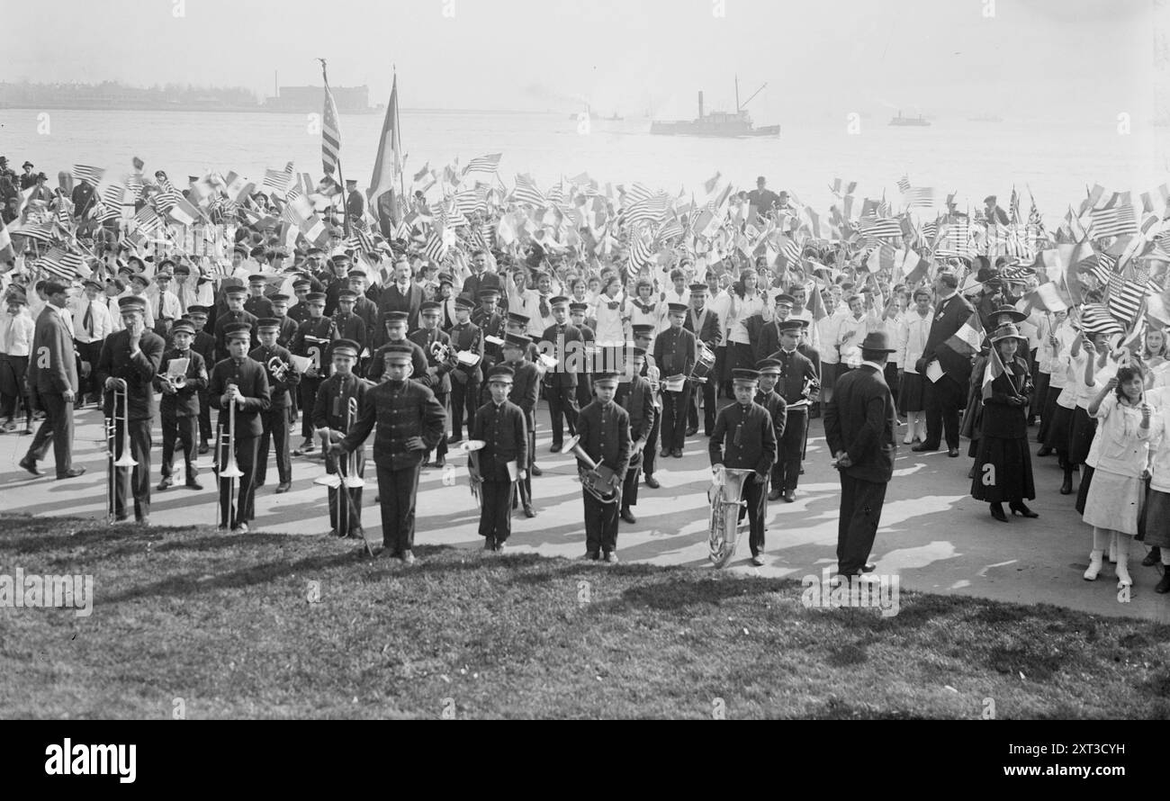 Raising flag of N.Y. City, 1916. Shows a group gathered for the raising ...