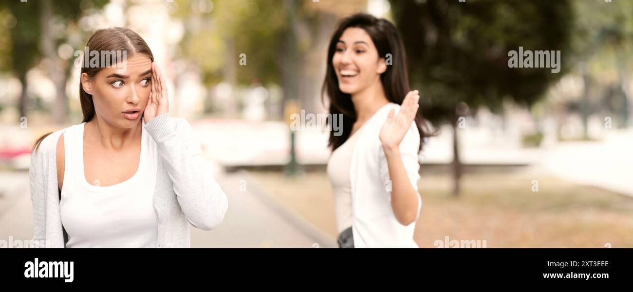 Happy girl greeting waving hand and friend ignoring her Stock Photo - Alamy