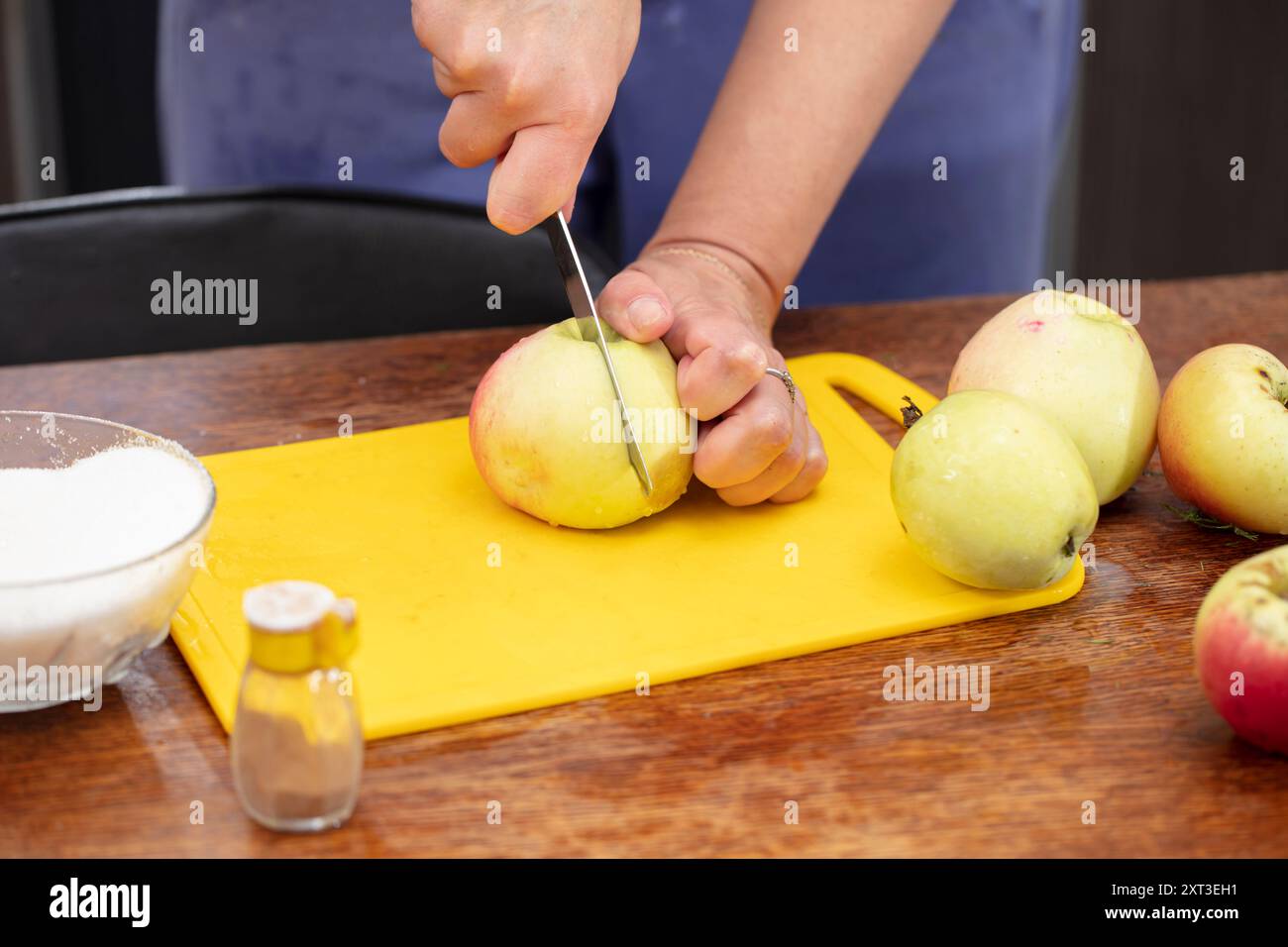 Hands cutting apples with a knife. Prepare healthy food from fruits ...