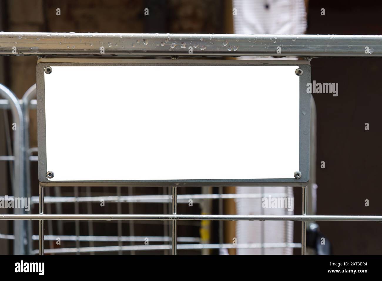 Blank white sign attached to metal trolley in urban setting, clipping ...