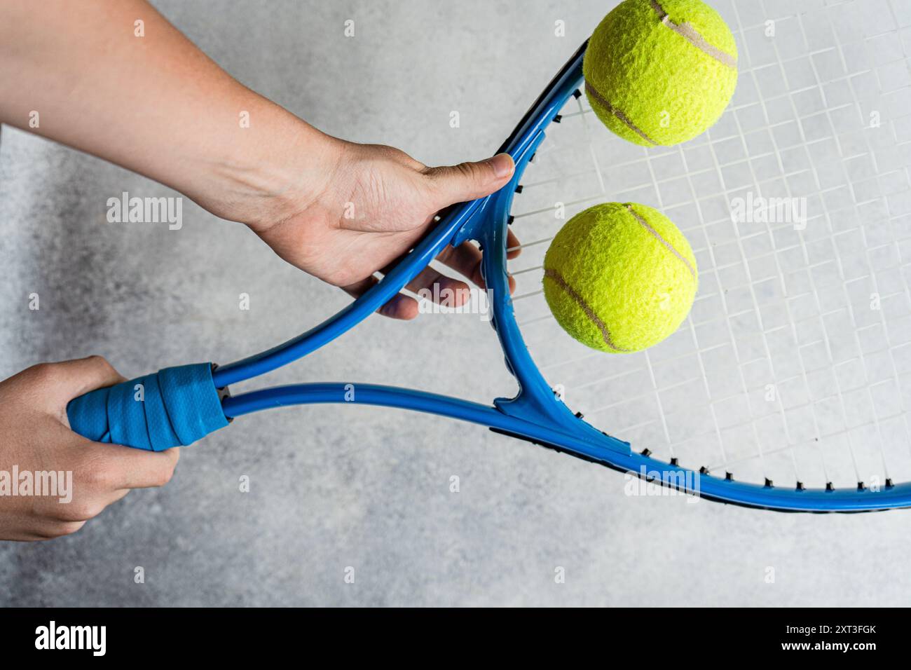 Detailed close-up image showing a person's hand deftly holding a tennis ...