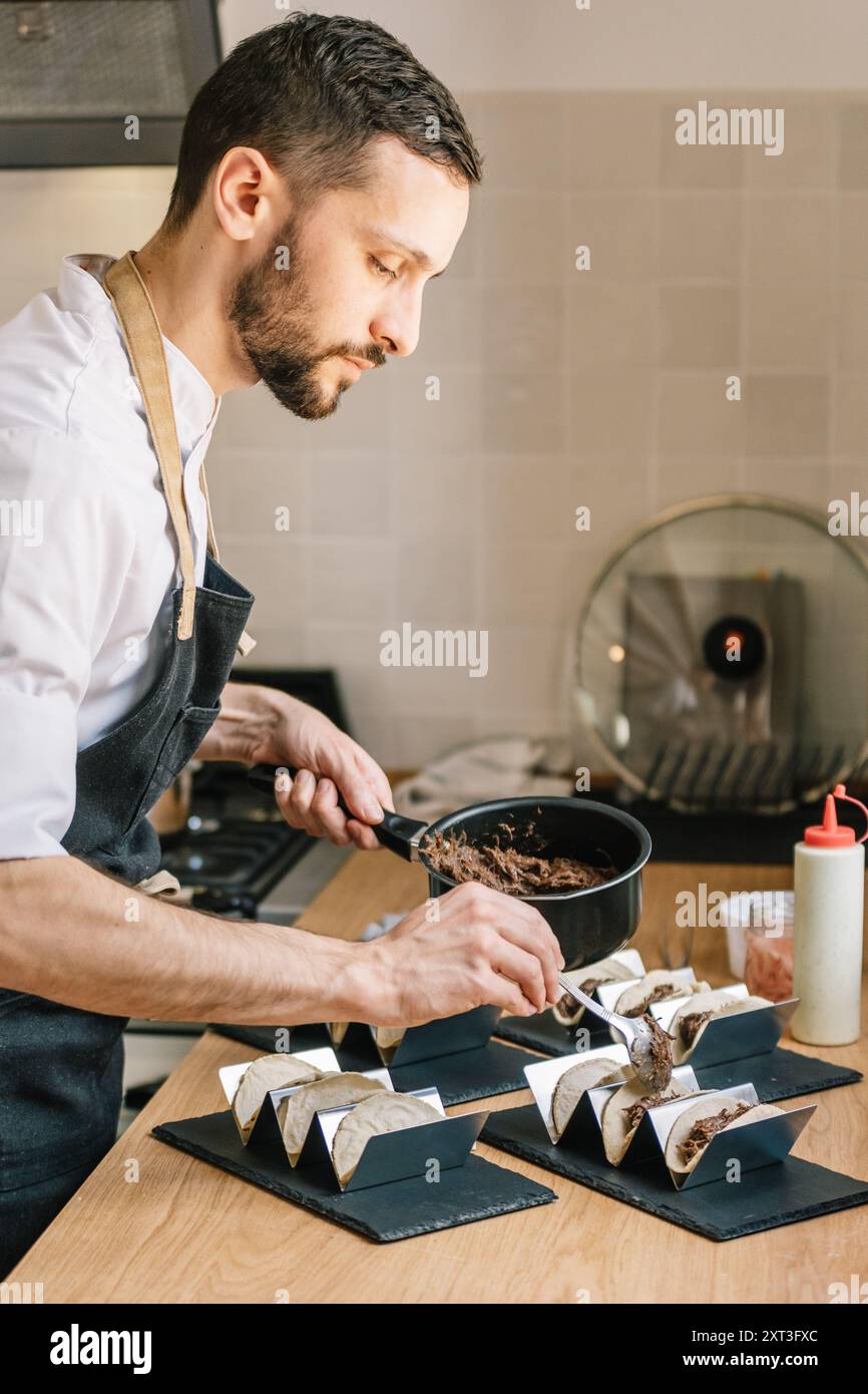 Kitchen chef fills cooking pot hi-res stock photography and images - Alamy