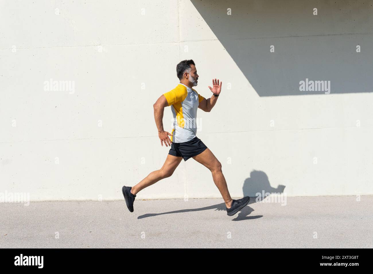 Side view of a dynamic scene featuring an Indian man running ...