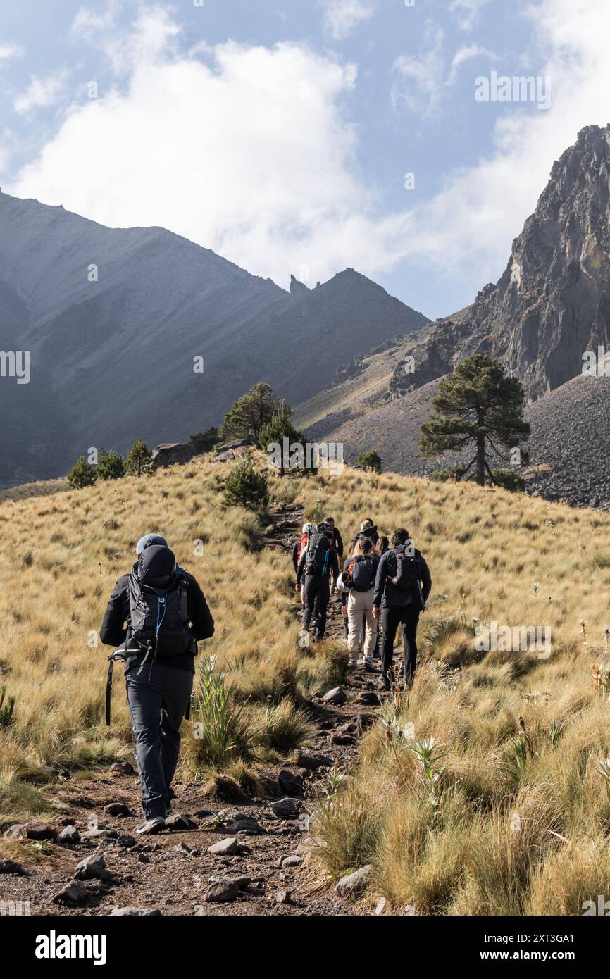 Back view of unrecognizable multicultural group of hikers, trekking up ...