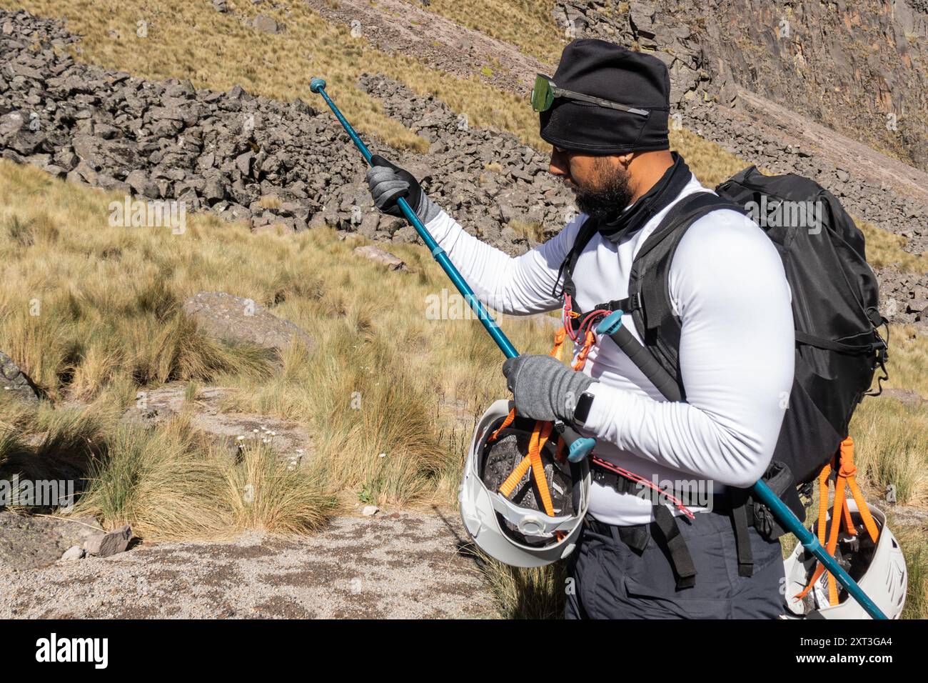 A Black male hiker, dressed in hiking gear and equipped with trekking ...