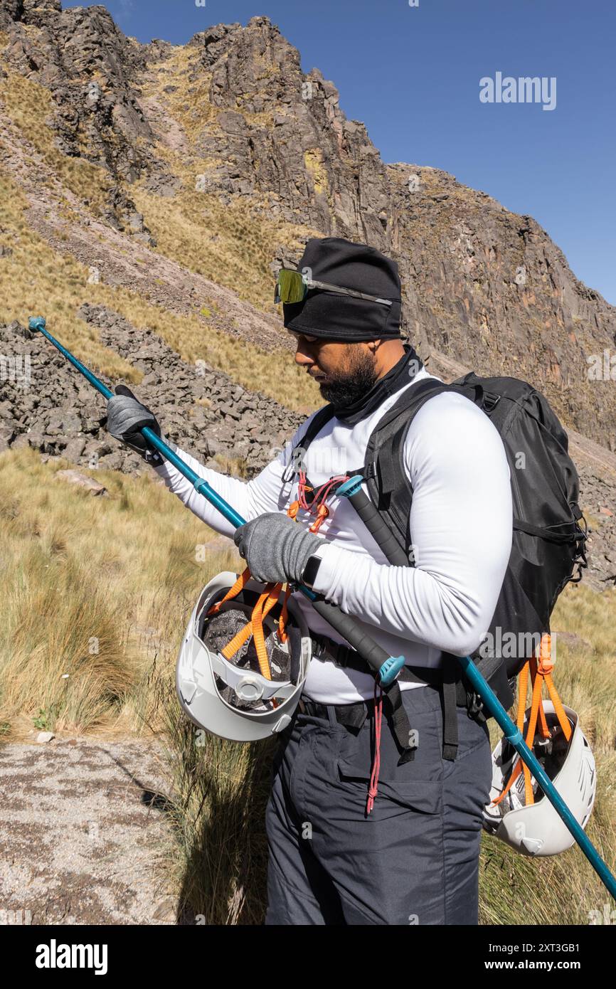A Black male hiker, dressed in hiking gear and equipped with trekking ...